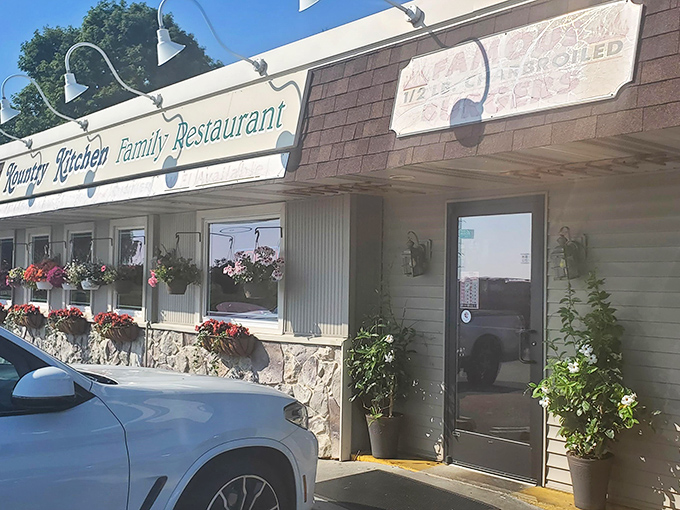 The welcoming facade of Kountry Kitchen, where hanging flower baskets add charm to this unassuming roadside gem in Manheim.