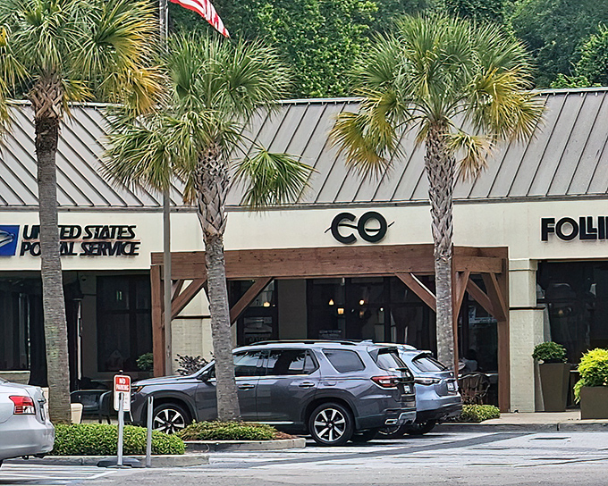 The sleek exterior of CO blends modern minimalism with warm wooden accents, promising culinary excitement behind those unassuming doors.