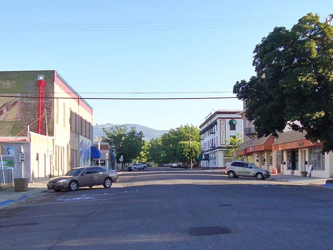 Main Street Susanville stretches toward mountain vistas, where historic brick buildings and blue skies create California's most affordable postcard setting.