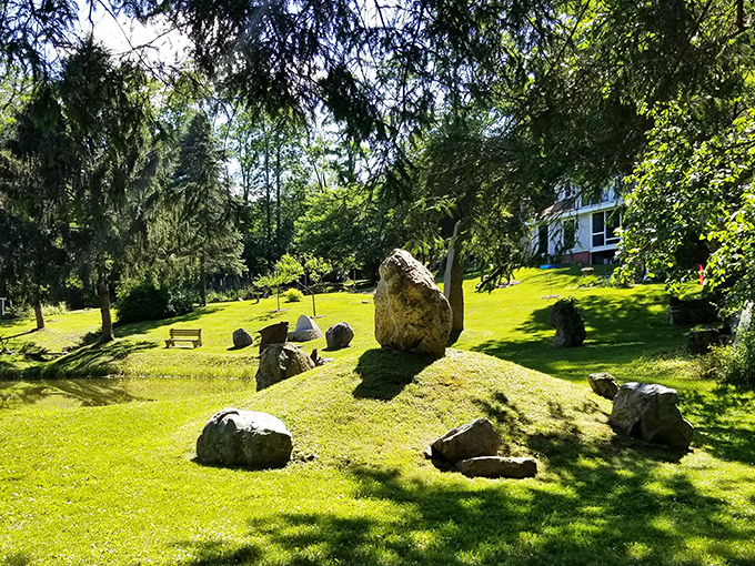 Standing stones scattered across verdant lawns create nature's chess set. The perfect spot for contemplating life's big questions or just enjoying a peaceful afternoon.