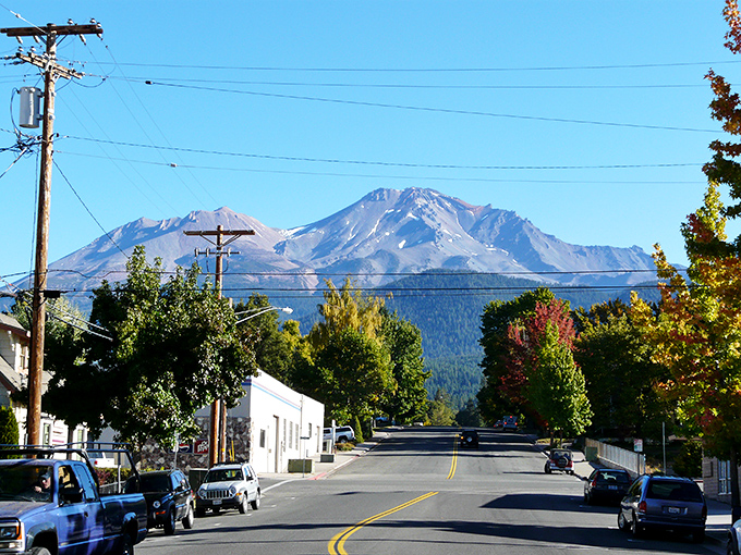The mountain plays peek-a-boo through the clouds, reminding you why postcards were invented before Instagram.