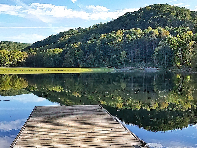 Mirror, mirror on the lake. The still waters perfectly reflect the surrounding hills, creating a double dose of autumn splendor for lucky visitors.