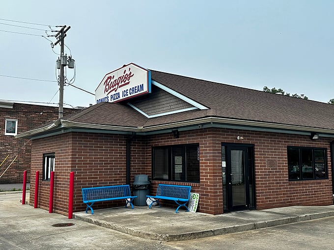 Brick exterior with blue benches&mdash;like a humble superhero whose powers include making Monday mornings bearable through sugar and carbs.