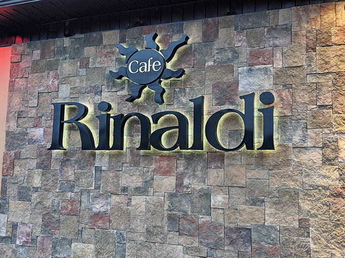 The stone facade of Cafe Rinaldi stands as Old Forge's culinary landmark, where those signature awnings have welcomed pizza pilgrims for generations.
