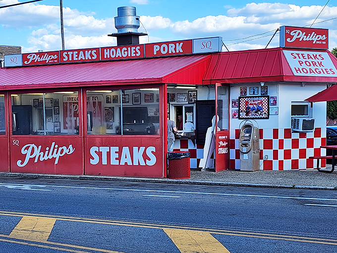 The iconic red and white checkerboard exterior of SQ Philip's Steaks stands as a beacon of hope for hungry Philadelphians seeking sandwich salvation.