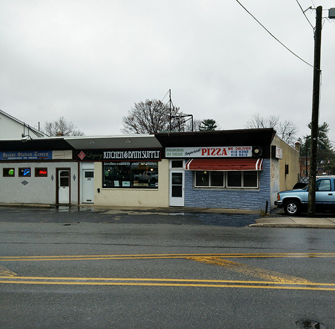 The blue brick facade of Imperial Pizza stands as a no-frills testament to pizza perfection in Secane. That neon "OPEN" sign might as well say "Pizza Paradise."