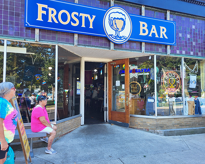 The iconic blue Frosty Bar sign welcomes hungry travelers like a beacon of hope. Island time officially begins when you walk through these doors.