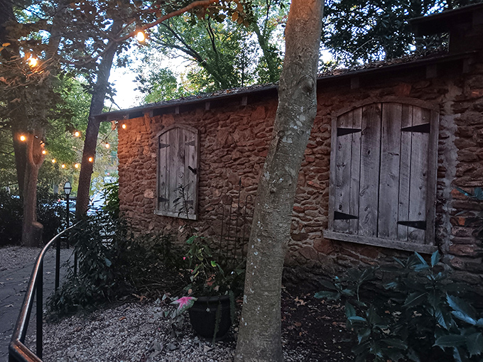 A stone cottage nestled among towering trees isn't your typical restaurant entrance&mdash;it's the beginning of a culinary fairy tale in Greenville.