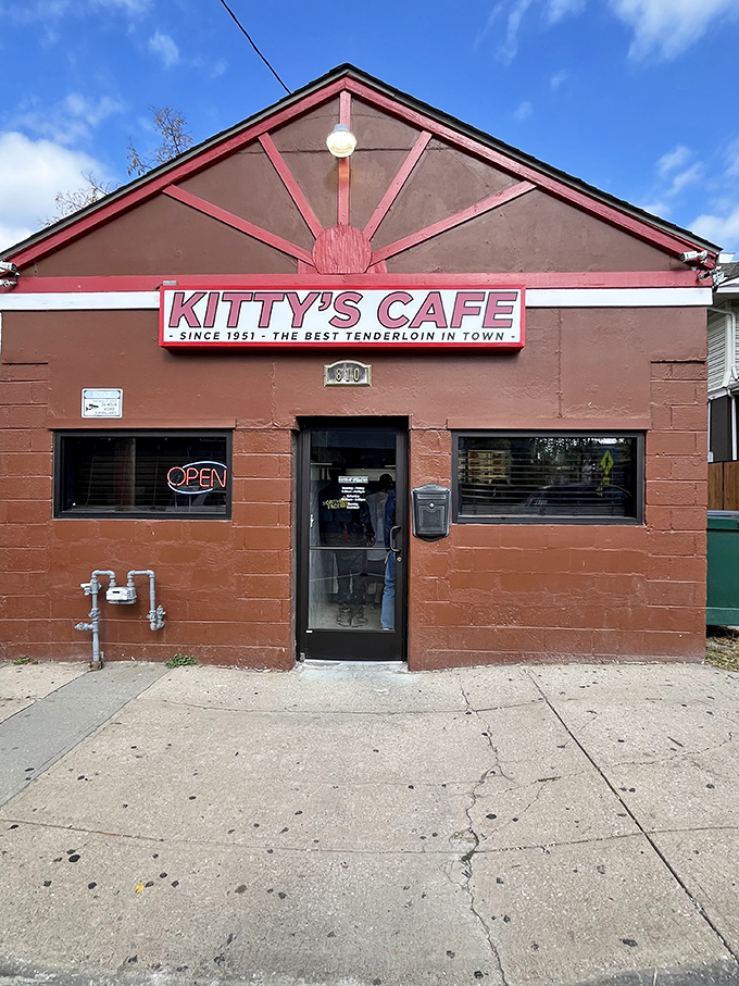 The unassuming brick exterior of Kitty's Cafe stands like a culinary time capsule, promising "THE BEST TENDERLOIN IN TOWN" since 1951.
