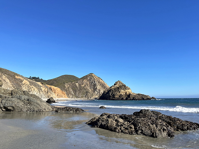 Nature's perfect postcard moment: dramatic cliffs embrace a pristine shoreline where the Santa Lucia Mountains meet the restless Pacific in spectacular harmony.