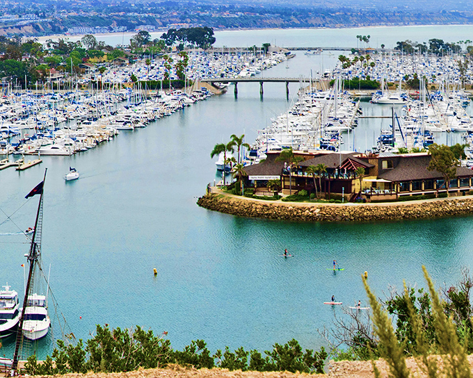 Dana Point Harbor's iconic horseshoe design showcases thousands of vessels from humble fishing boats to luxury yachts, a floating neighborhood of nautical dreams.
