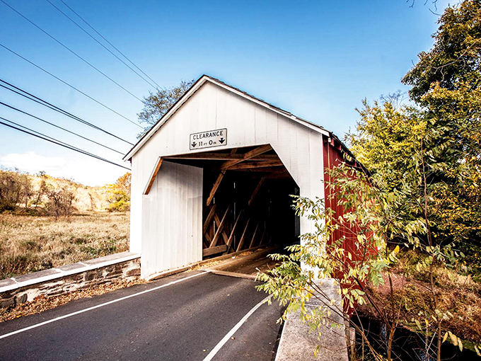 The classic white and red Erwinna Covered Bridge stands like a time machine disguised as architecture, beckoning travelers to slow down and appreciate Pennsylvania craftsmanship.