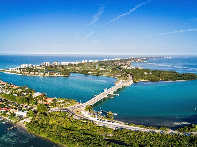 Aerial paradise: Where emerald waters embrace a slender island, creating Florida's version of a watercolor masterpiece come to life.