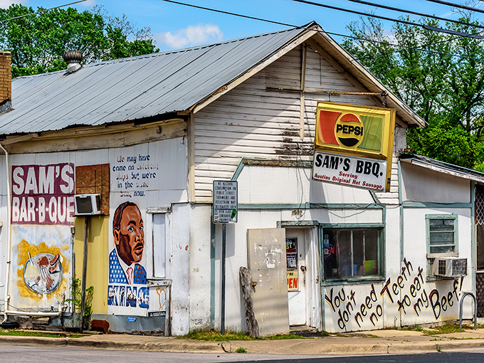 Sam's Bar-B-Que stands defiant against time and gentrification, its weathered white walls and hand-painted murals a testament to authentic Austin barbecue tradition.