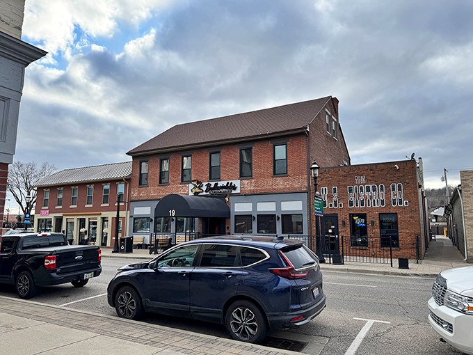 Bullwinkle's brick exterior with its signature black awning and tropical patio plants creates that perfect "come as you are, leave happier" neighborhood vibe.
