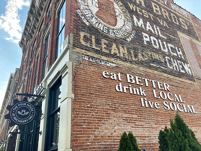 The historic brick facade of The Pour House at Machinery Hall proudly displays its mantra: "eat BETTER, drink LOCAL, live SOCIAL." Industrial heritage meets modern gastronomy.