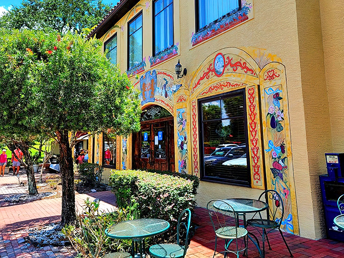 Colorful murals frame the entrance like a storybook come to life, while outdoor tables invite you to linger over coffee and pastries beneath Florida's sunshine.