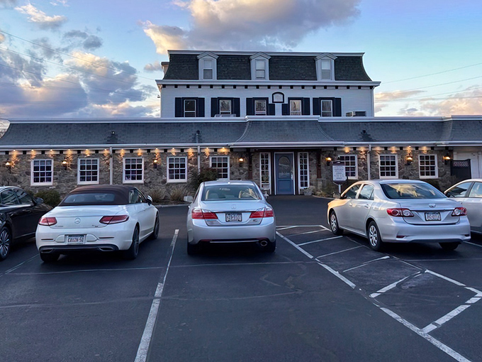 The historic stone fa&ccedil;ade of Spring House Tavern glows at dusk, its distinctive mansard roof and warm lighting promising culinary comfort within.