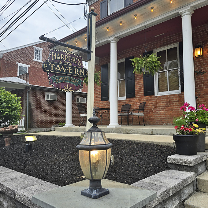 The classic brick exterior of Harper's Tavern welcomes you like an old friend, complete with white columns and that iconic vintage sign promising good times ahead.
