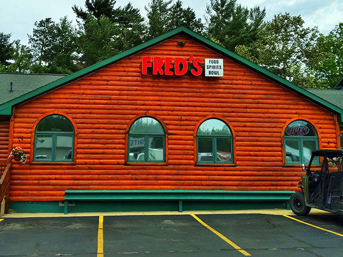 Fred's bright orange log cabin exterior stands out like a friendly beacon in the northwoods, practically shouting "Good food inside!" to hungry travelers passing by.