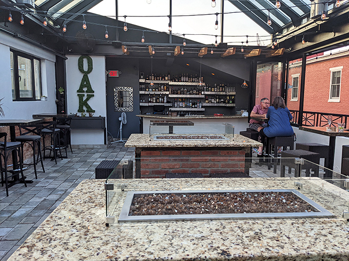 Three Oak's rooftop bar offers an urban oasis where string lights twinkle above granite fire pits and craft cocktails flow freely.