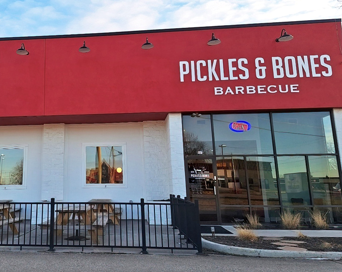 The bold red exterior of Pickles & Bones Barbecue isn't just a color choice&mdash;it's a warning sign that something seriously delicious is happening inside.