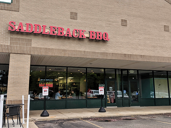 The unassuming strip mall exterior of Saddleback BBQ proves once again that the best barbecue often hides in plain sight, like a smoke ring waiting to be discovered.
