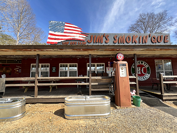 The American flag proudly waves above this rustic BBQ haven, promising patriotic flavors that'll have you pledging allegiance to slow-smoked goodness.