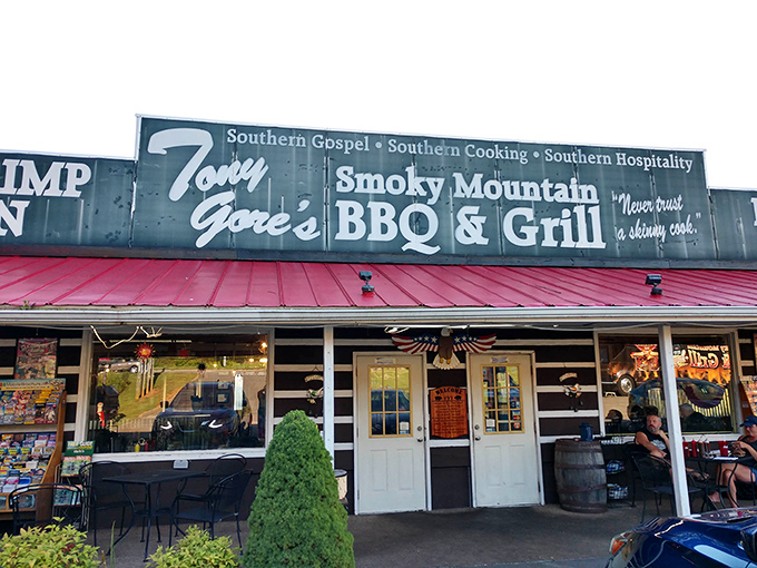 The red-roofed roadside haven beckons hungry travelers with its bold promise of "Best Ribs in the Smokies." Your stomach is already applauding the decision to stop.