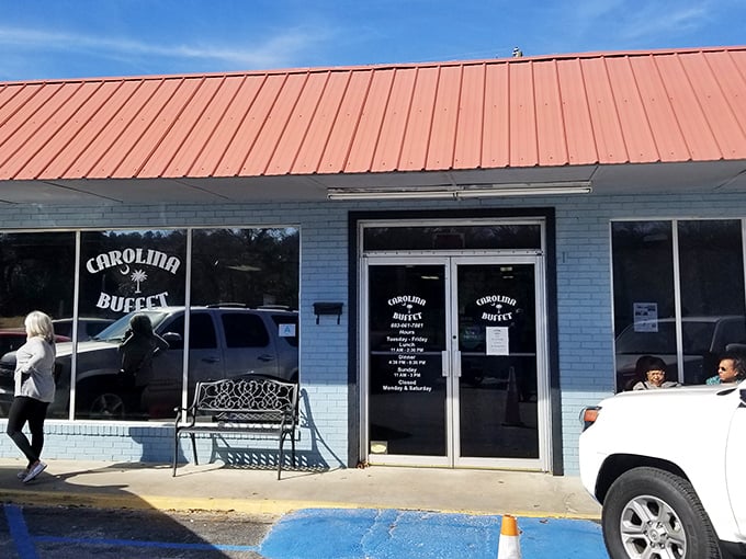The unassuming blue exterior with its bright orange roof houses culinary treasures that locals drive miles to experience. Southern food paradise hiding in plain sight.