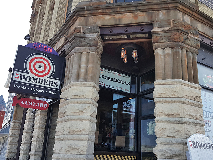 The historic stone facade of AJ Bombers stands like a culinary fortress, its target-logo sign promising a direct hit to your hunger pangs.
