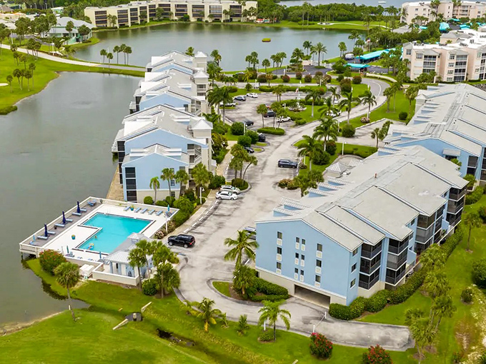 Aerial paradise where your retirement dollars stretch further than your golf swing. Blue-roofed buildings embrace waterways like old friends.