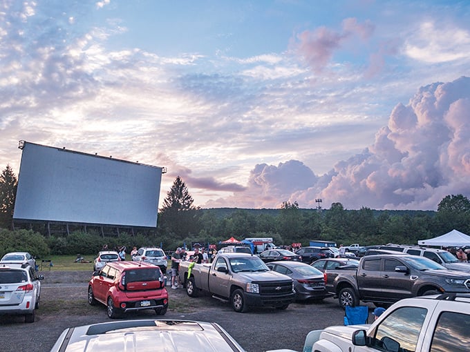 Cars line up like eager moviegoers from decades past, ready for that uniquely American ritual of cinema under stars.