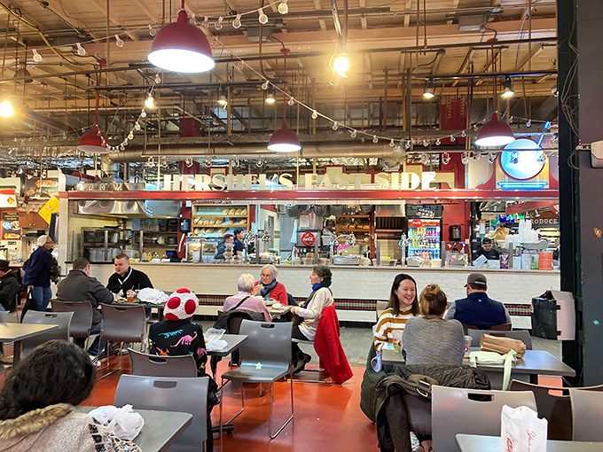 The bustling heart of Hershel's, where sandwich artistry happens in full view. Red pendant lights cast a warm glow over this temple of traditional deli fare.