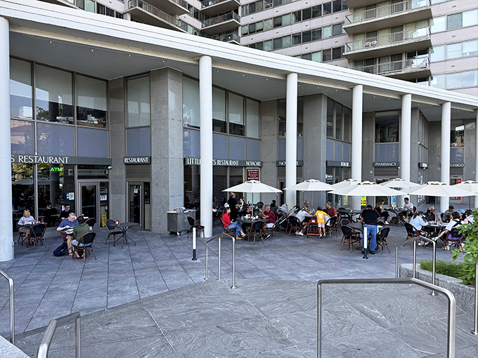 Little Pete's modern exterior welcomes diners with a spacious patio where Philadelphians gather to enjoy classic comfort food under bright umbrellas.