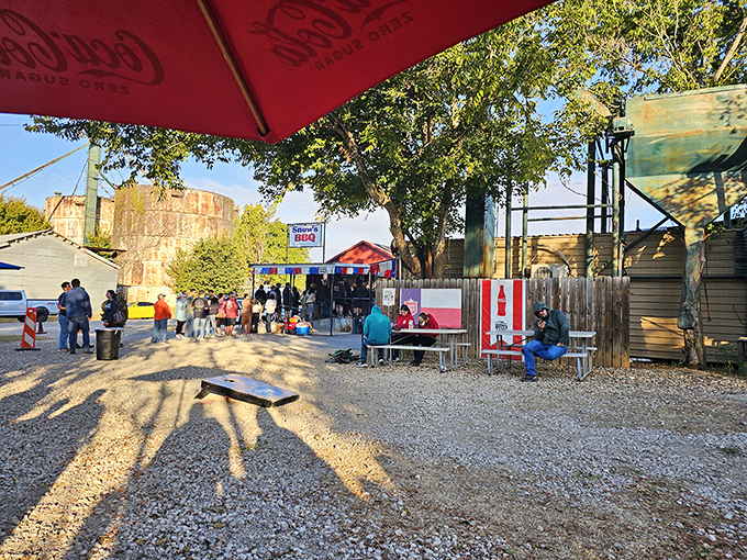 The pilgrimage begins here &ndash; a humble gravel lot under Texas skies where barbecue dreams come true and morning shadows stretch like hungry customers.