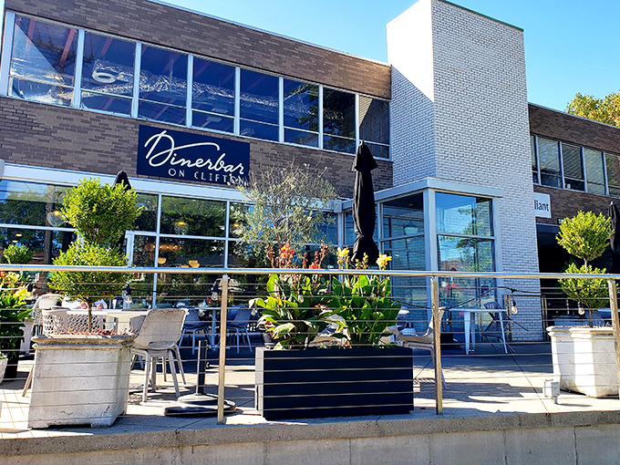 The modern facade of Dinerbar on Clifton welcomes diners with its clean lines and inviting patio space&mdash;architectural proof that good taste extends beyond the menu.