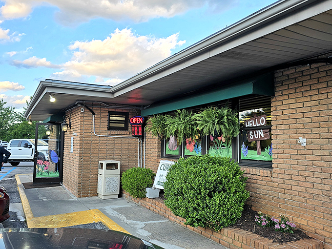The distinctive green entrance panel flanked by lanterns gives Clyde's that perfect blend of mountain charm and no-nonsense diner appeal.