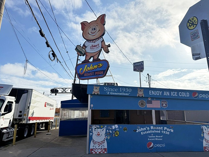 Standing tall against the Philly skyline, that smiling pig has witnessed decades of sandwich perfection. The James Beard Award banner isn't just decoration—it's a well-earned badge of honor.