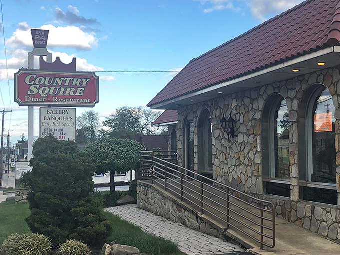 The stone facade of Country Squire Diner stands like a culinary castle in Broomall, complete with that iconic burgundy roof and welcoming entrance ramp.