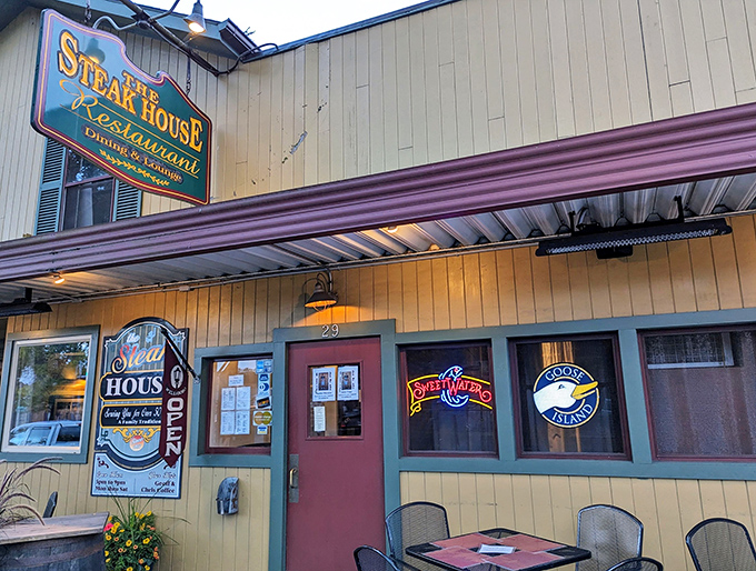 The charming exterior of The Steak House beckons hungry travelers with its classic awning and inviting outdoor seating&mdash;a Main Street fixture that promises culinary comfort.
