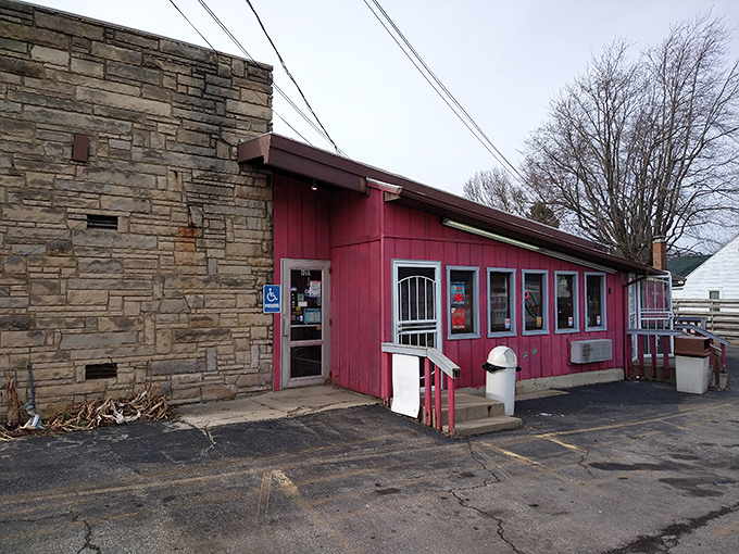 The iconic stone chimney and vibrant red exterior of Porky's Drive-In stand as a time capsule of Americana in Mansfield, where culinary memories are made daily.