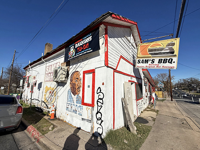 Sam's Bar-B-Que stands defiant against time and gentrification, its weathered white walls and hand-painted murals a testament to authentic Austin barbecue tradition.