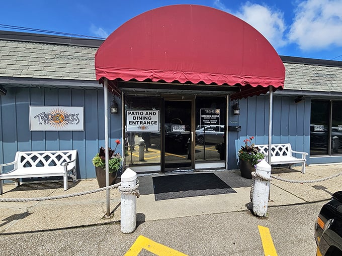The unassuming blue exterior with its cheerful red awning is like that friend who doesn't brag but always delivers. Culinary treasures await inside!