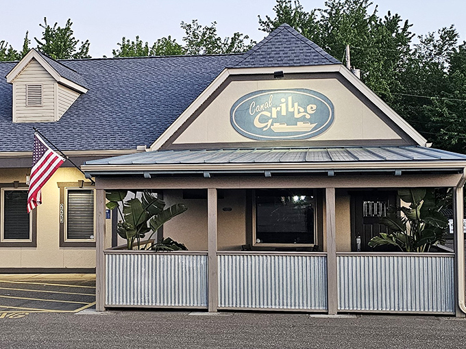 A classic American flag waves hello outside Canal Grille's inviting entrance, where comfort food dreams come true in Canal Fulton.