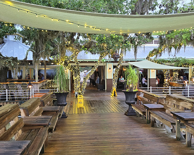The outdoor deck at Cap's is where memories are made &ndash; wooden benches, twinkling lights, and the promise of seafood that will haunt your dreams.
