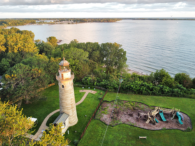 The Erie Land Lighthouse stands majestically against Lake Erie's shimmering waters, a honey-colored sentinel that's been keeping watch since before Instagram was even a concept.