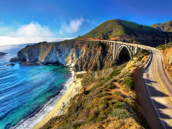 Highway 1 unfurls like nature's red carpet, hugging California's dramatic coastline. The road ahead promises adventures that no smartphone screen could ever do justice.