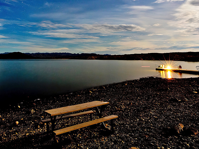 Twilight transforms Alamo Lake into nature's own light show, with a lonely picnic table scoring front-row seats to the spectacle. Desert dining with a view!