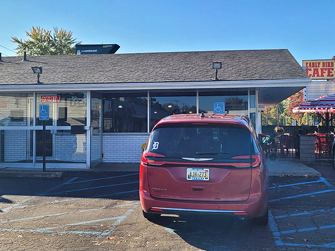 The unassuming exterior of Early Bird Cafe in Keego Harbor &ndash; where breakfast dreams come true behind that modest white brick facade.